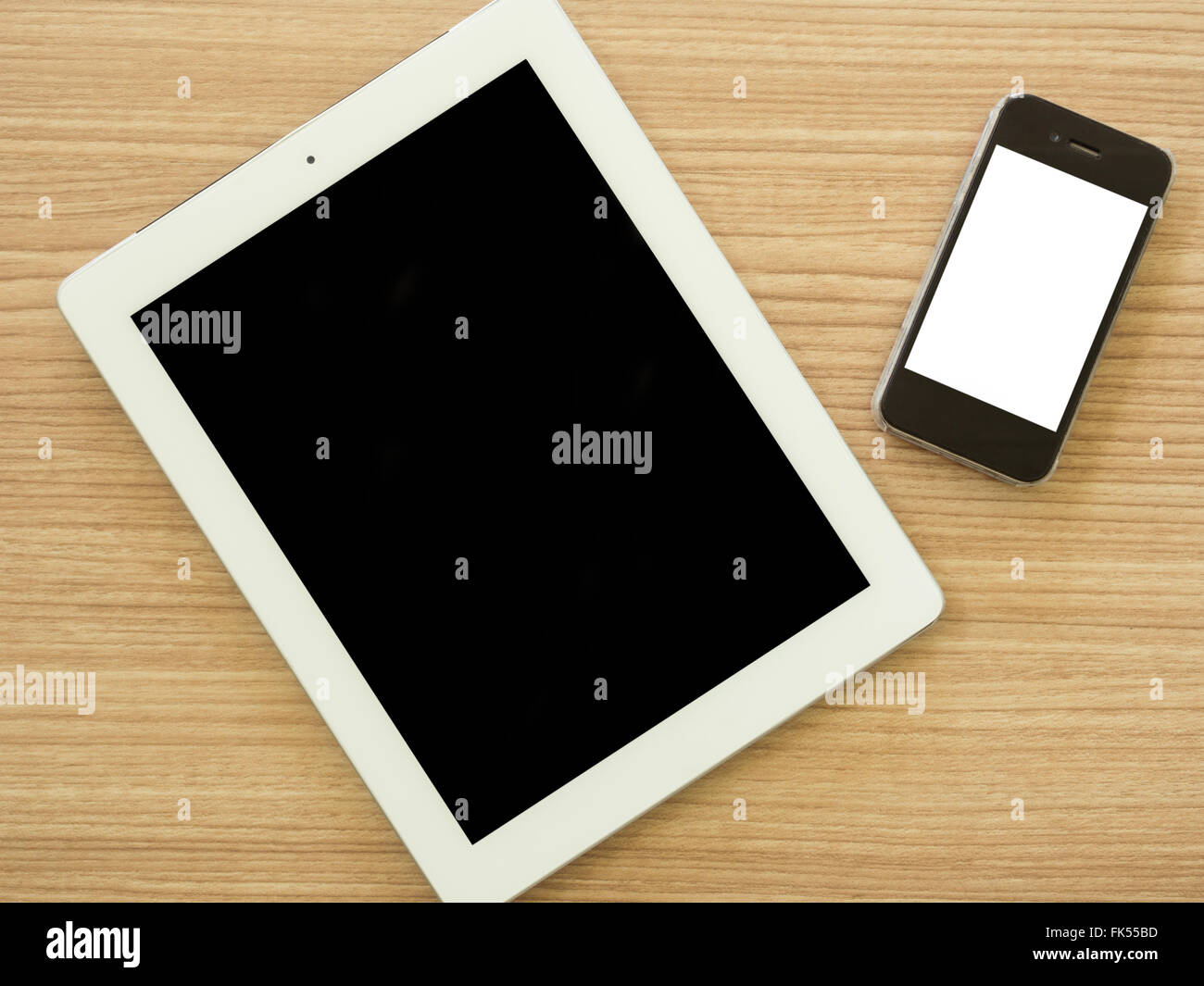 tablet computer and smart phone on wooden table Stock Photo - Alamy