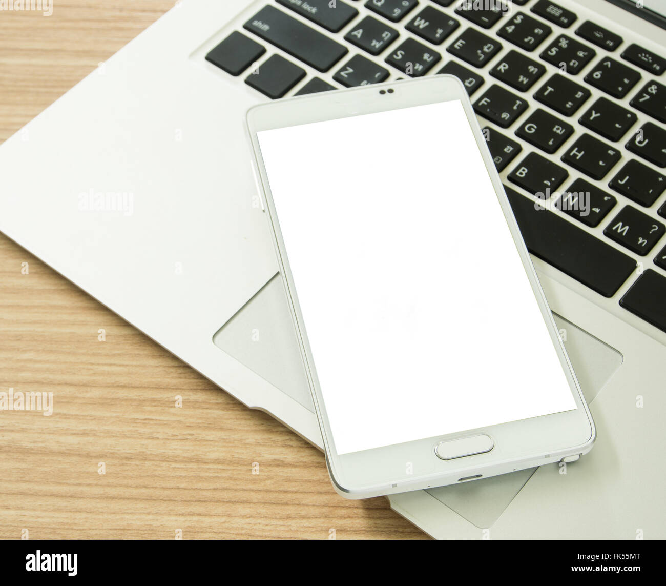 smart phone on keyboard laptop computer Stock Photo - Alamy