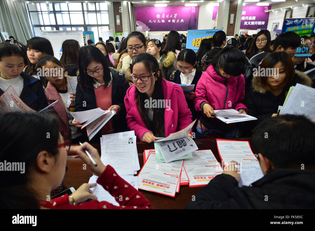 Tianjin, China. 7th Mar, 2016. Female college students consult with an ...
