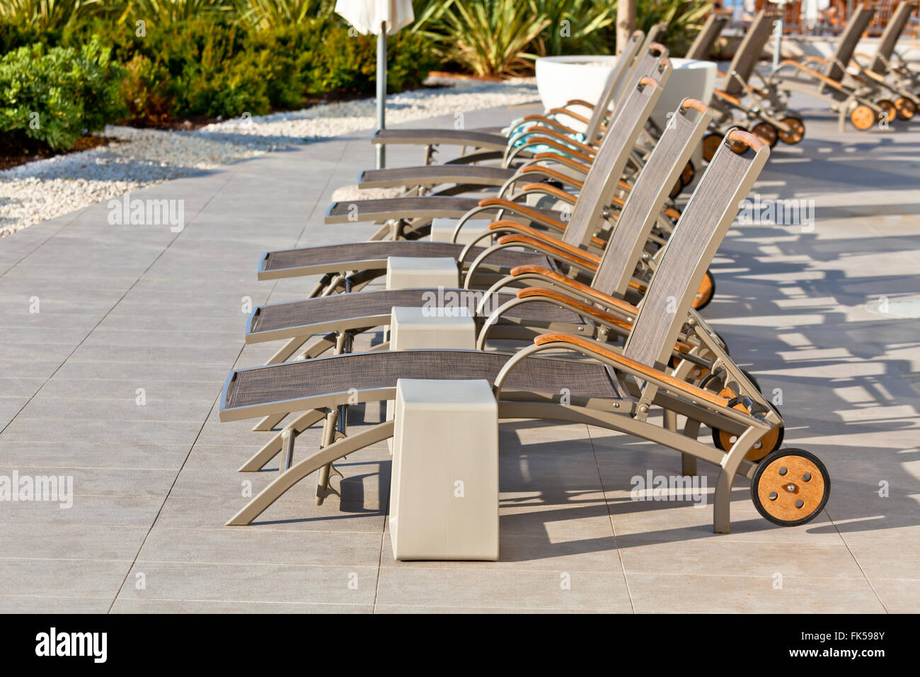 Hotel Wooden Poolside Chairs. Horizontal shot Stock Photo - Alamy