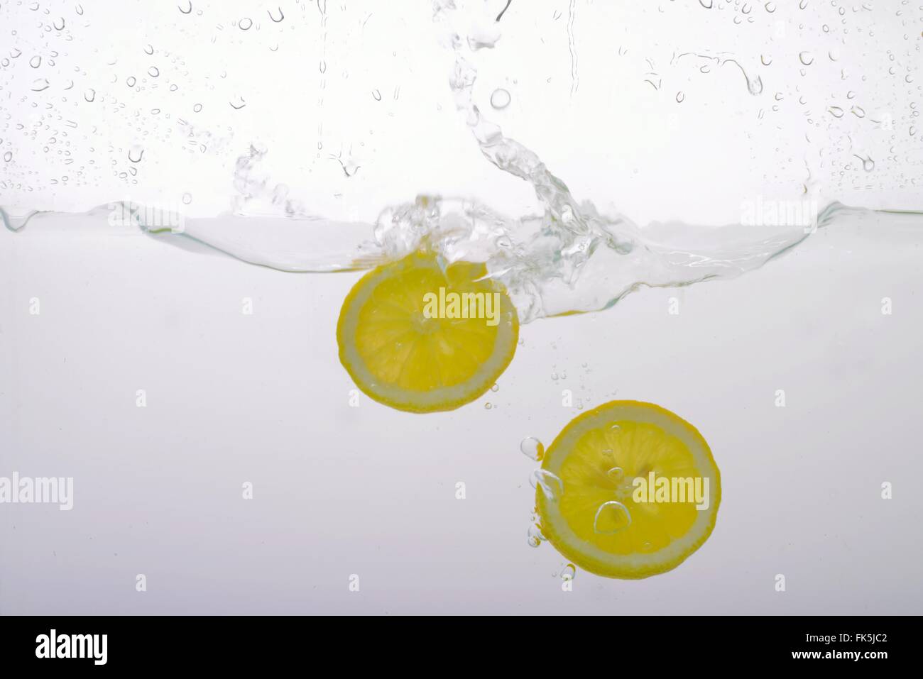 Lemon slices in water Stock Photo - Alamy