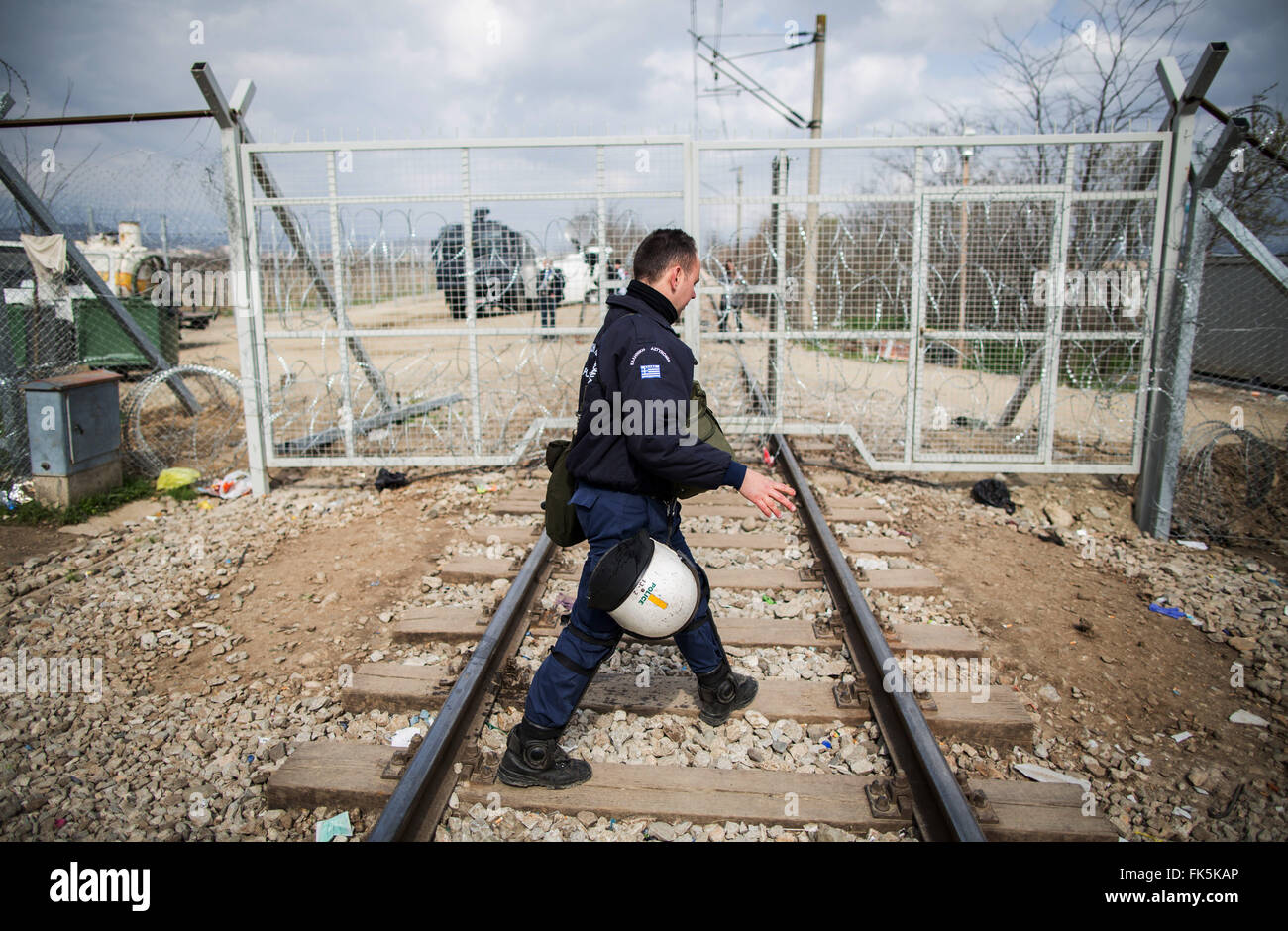 Idomeni, Greece. 07th Mar, 2016. A Greek police officer walks past the ...