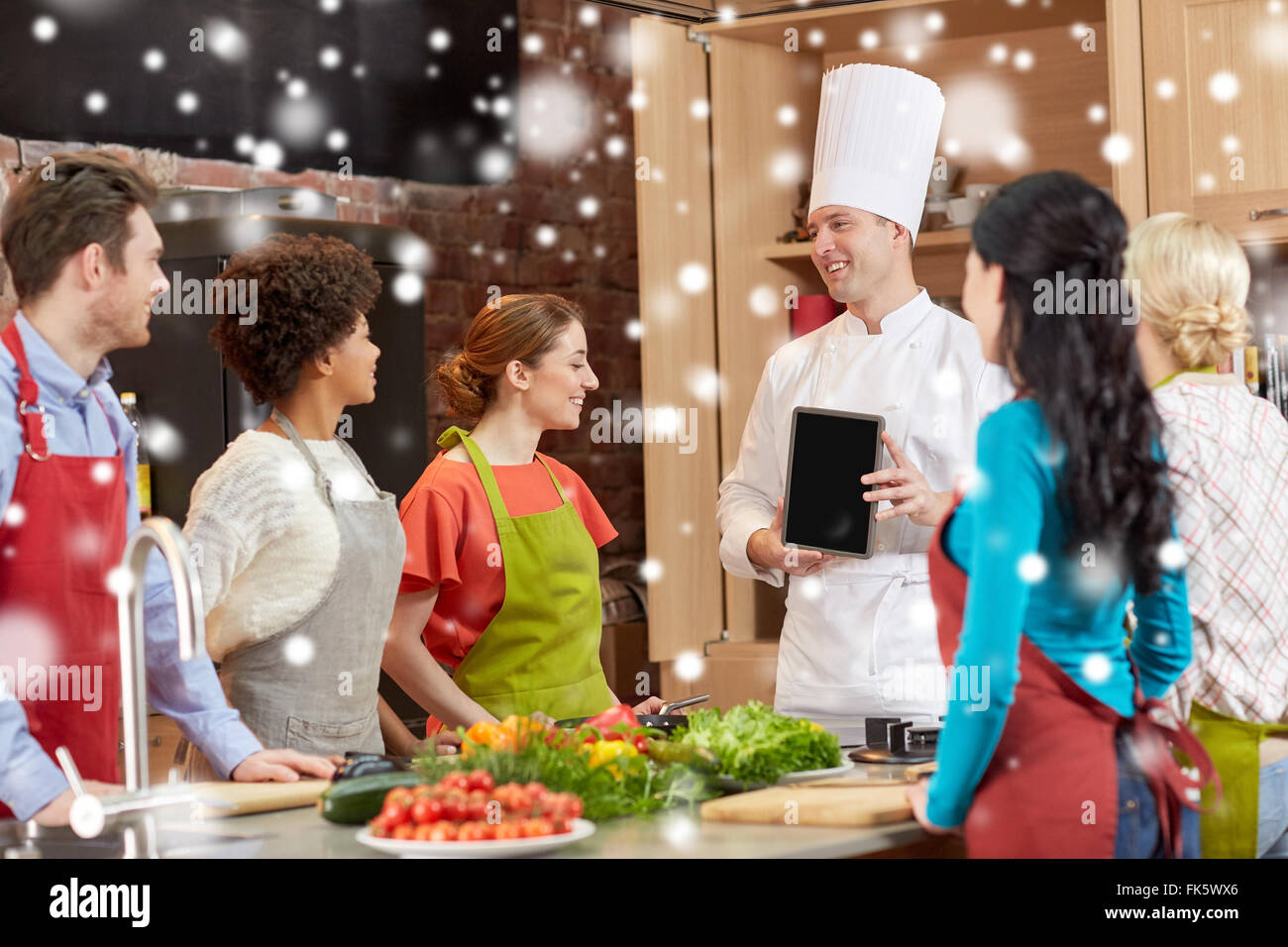 happy friends with chef and tablet pc in kitchen Stock Photo - Alamy