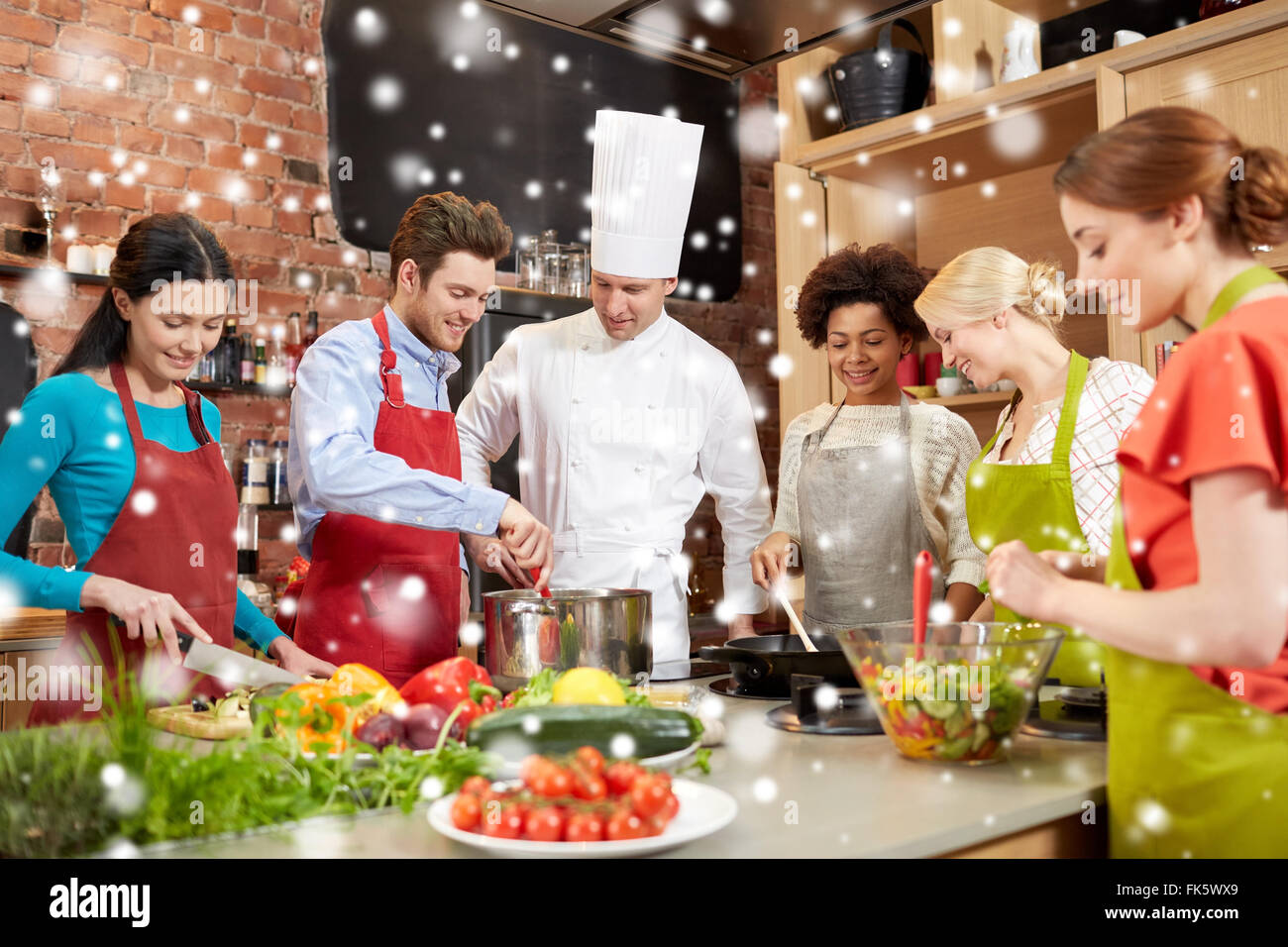 happy friends and chef cook cooking in kitchen Stock Photo - Alamy
