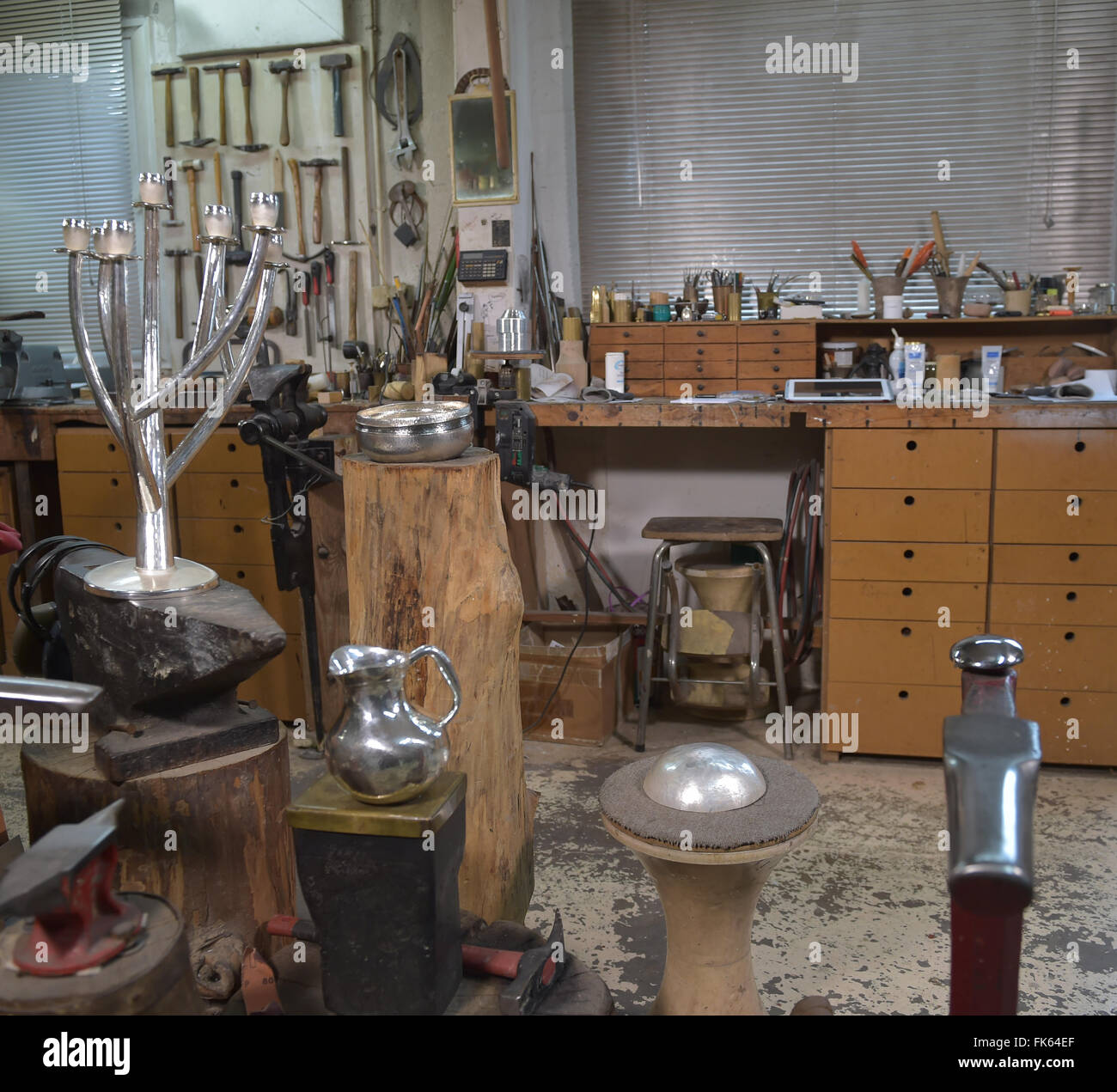 Pitcher and candlestick silver in Master goldsmith workshop Stock Photo ...