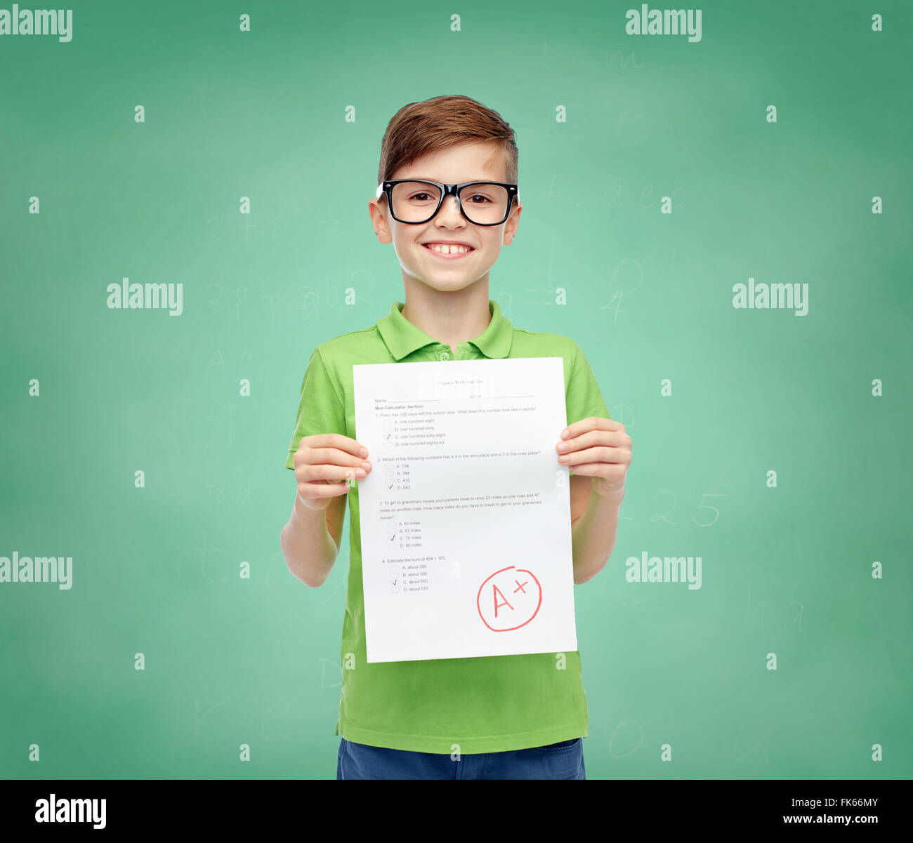 happy boy in eyeglasses holding school test result Stock Photo - Alamy