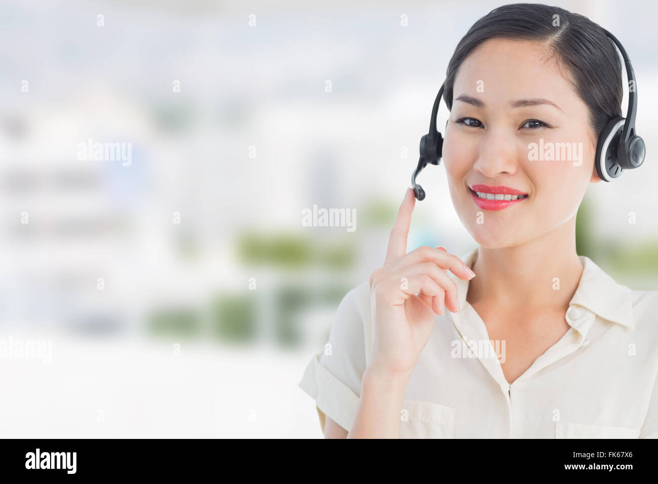 Composite image of beautiful smiling female executive with headset ...