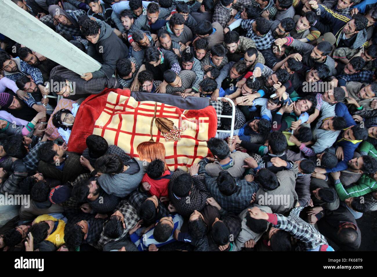 Tral, India. 07th Mar, 2016. Kashmiri Muslims surround the dead body of ...