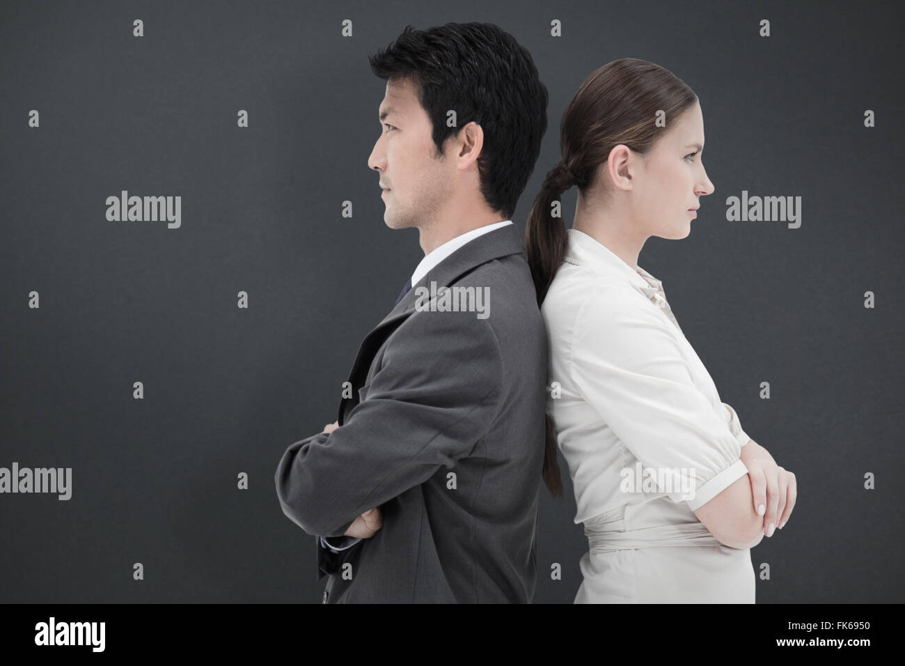 Composite image of portrait of serious business people standing back-to ...