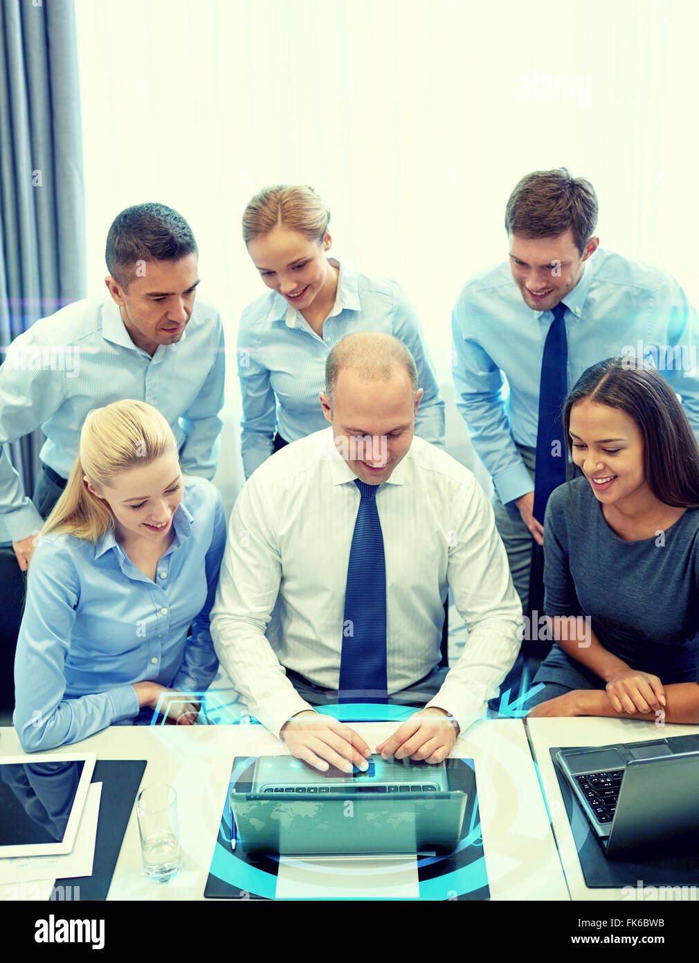 smiling business people with laptop in office Stock Photo - Alamy