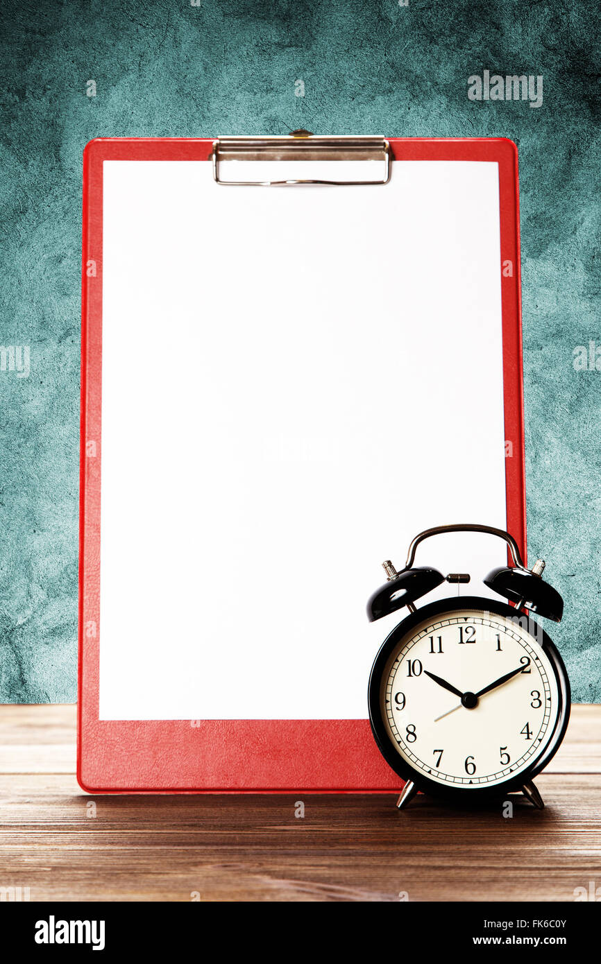 Blank paper sheet and alarm clock Stock Photo - Alamy