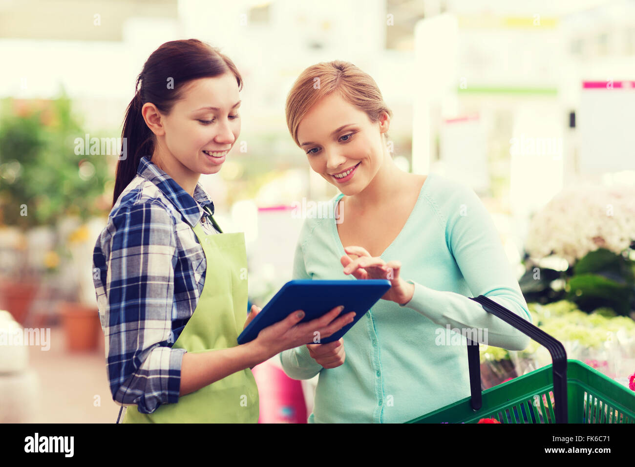 happy women with tablet pc in greenhouse Stock Photo - Alamy
