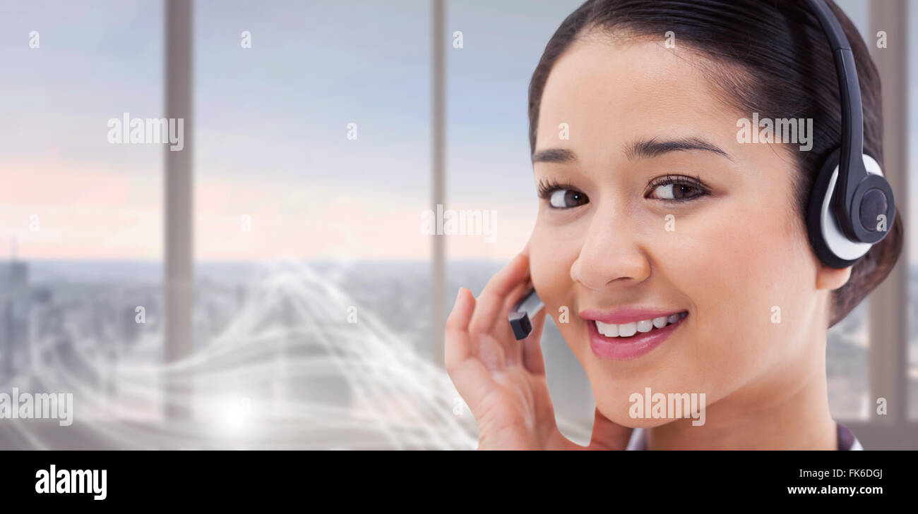 Composite image of close up of a smiling operator posing with a headset ...