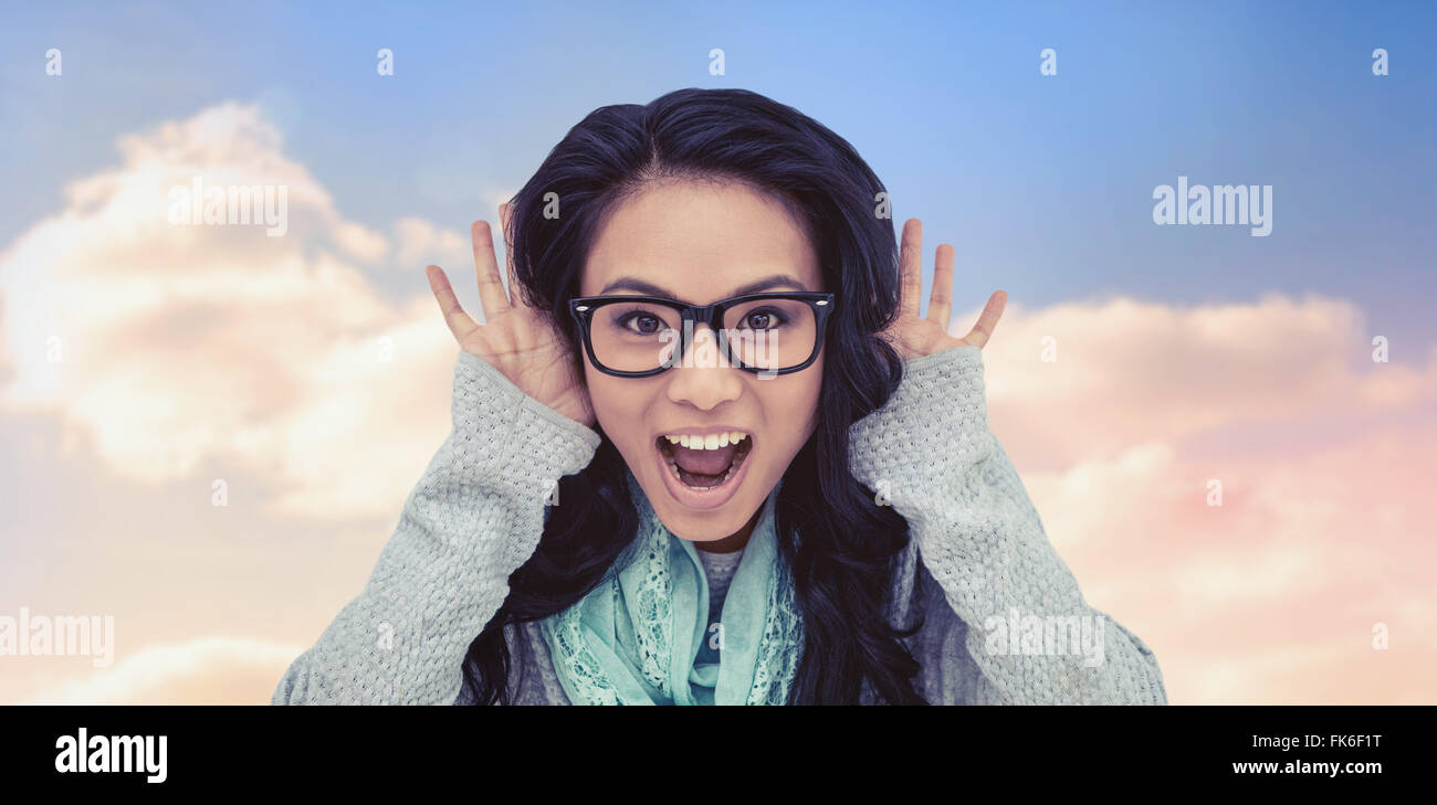 Composite image of asian woman shouting to the camera Stock Photo - Alamy