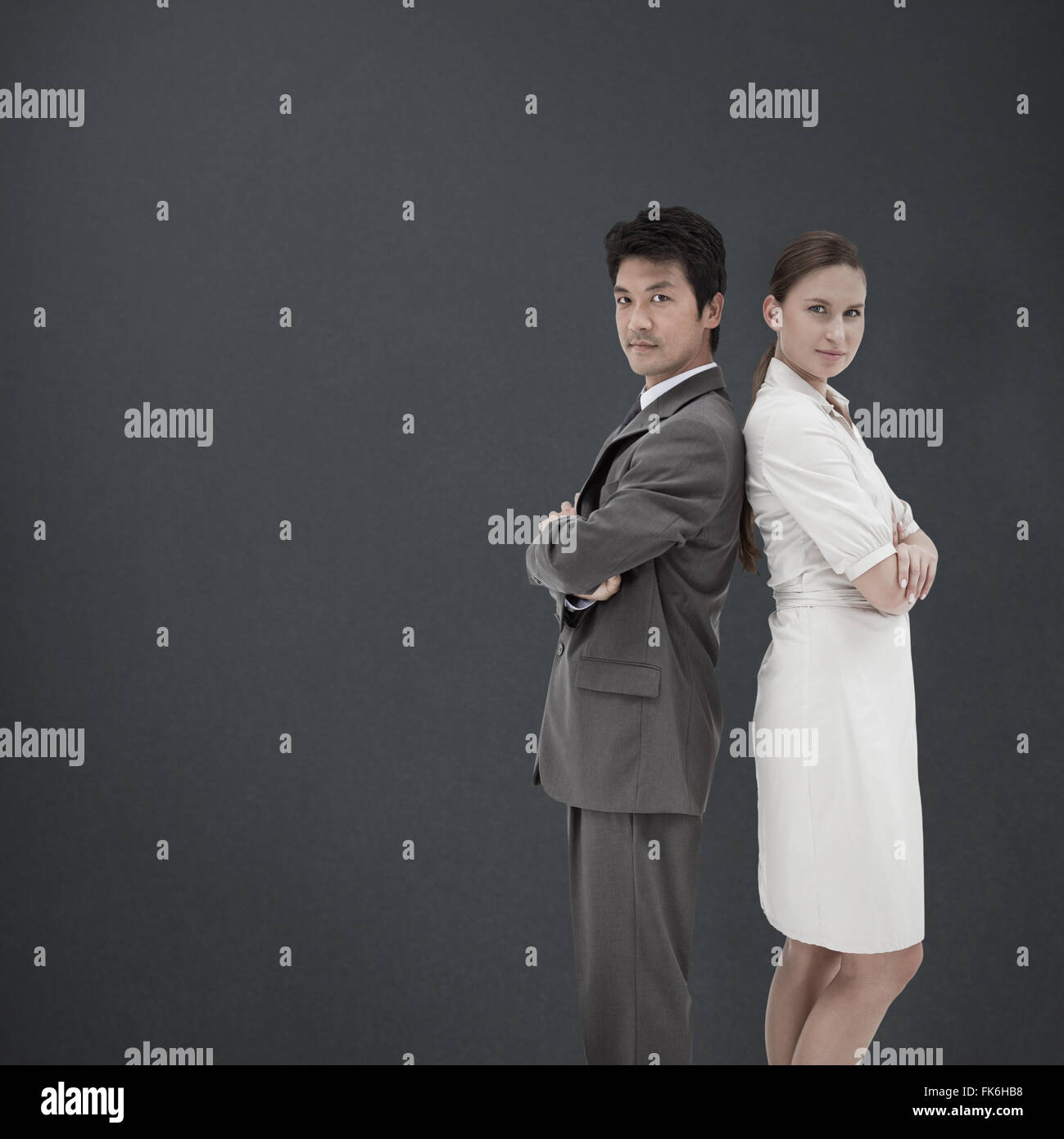 Composite image of portrait of business people standing back-to-back ...