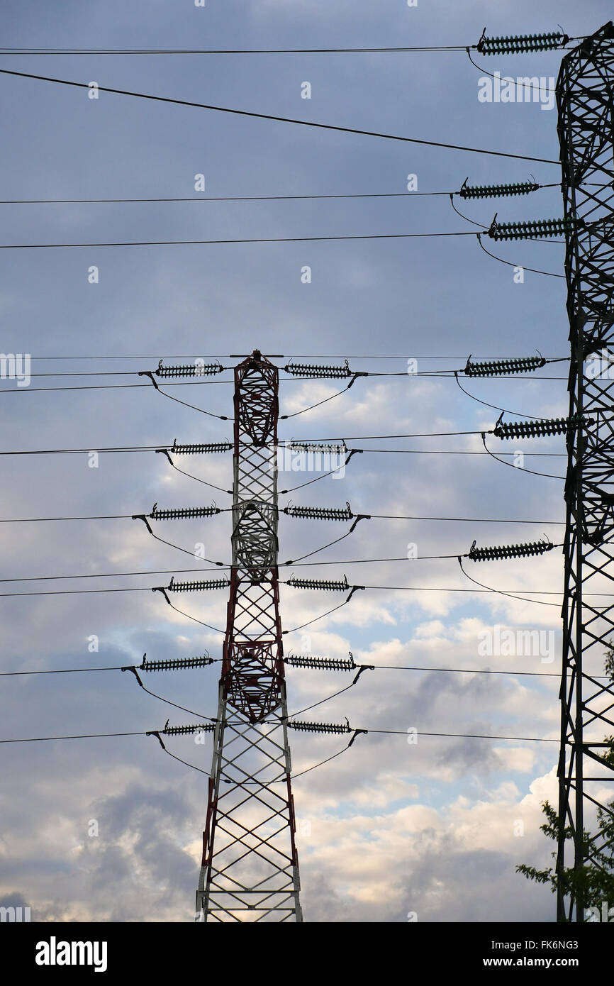 Power lines in sunny rural field Stock Photo - Alamy