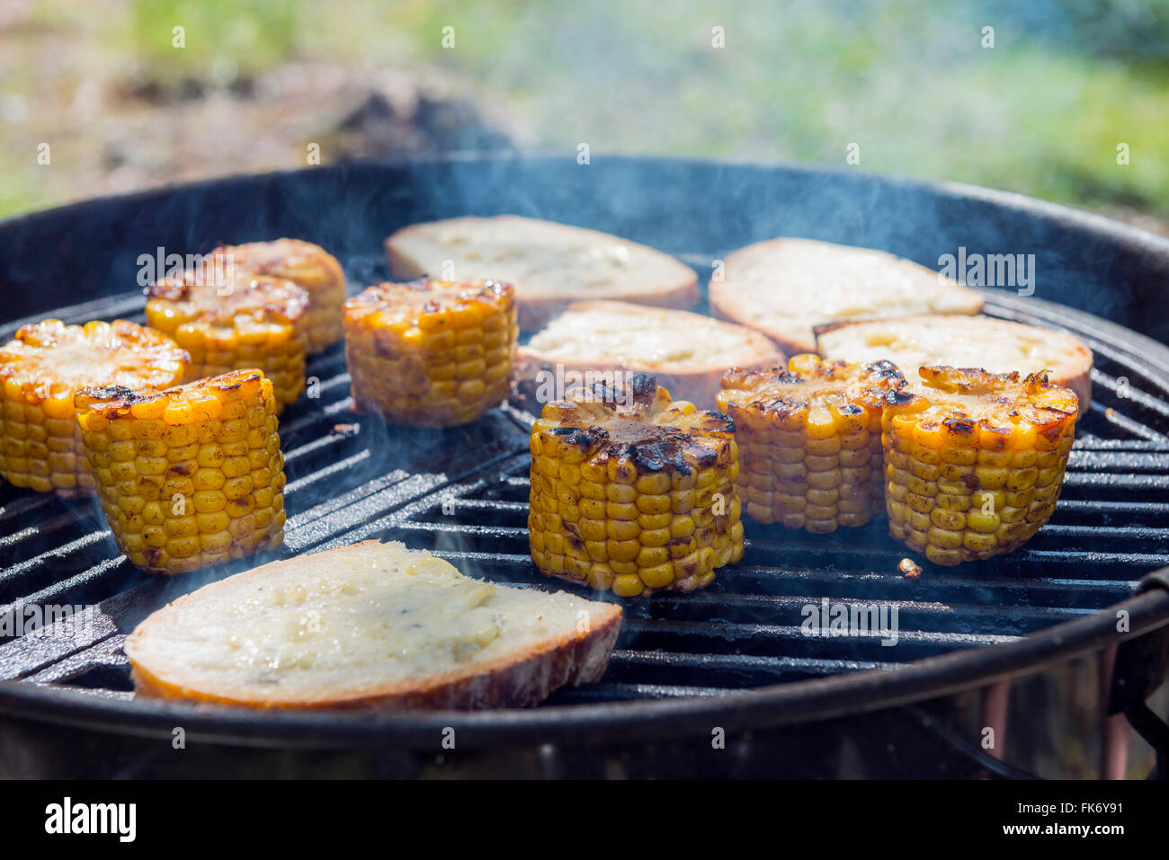 Corn and garlic bread on the grill Stock Photo - Alamy