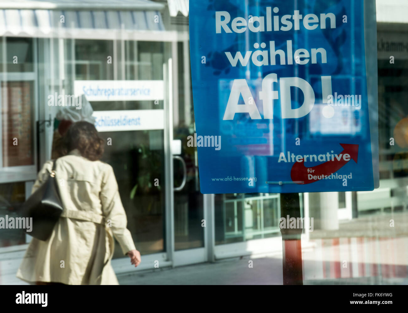 A woman passing a campaign poster of AfD party in Vierchen, Germany, 7 ...
