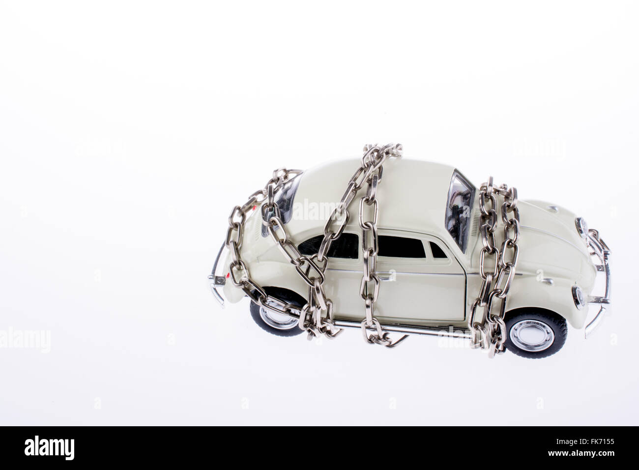 Chained white car on white background Stock Photo - Alamy