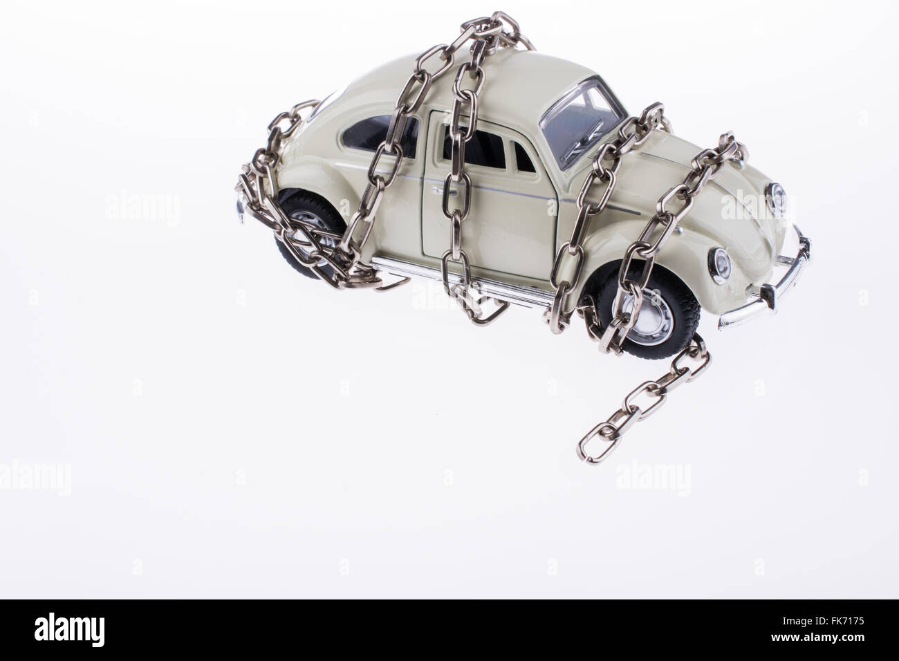Chained white car on white background Stock Photo - Alamy