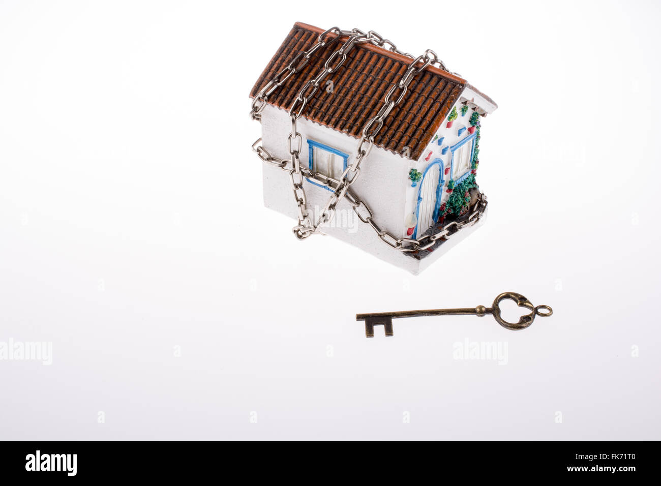 key and a house in chains on a white background Stock Photo - Alamy