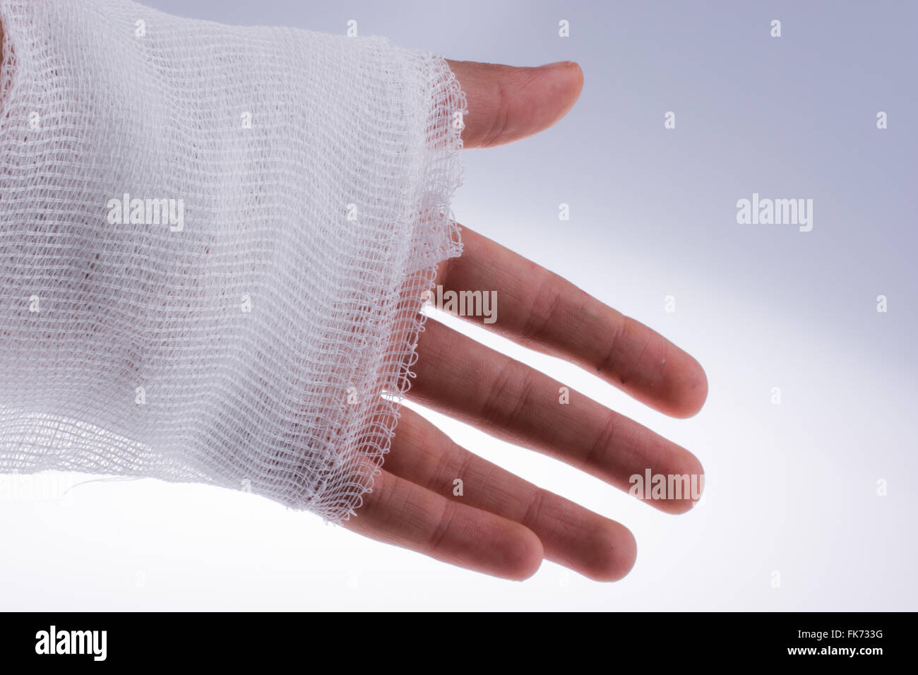 hand wrapped in white bandage on a white background Stock Photo - Alamy