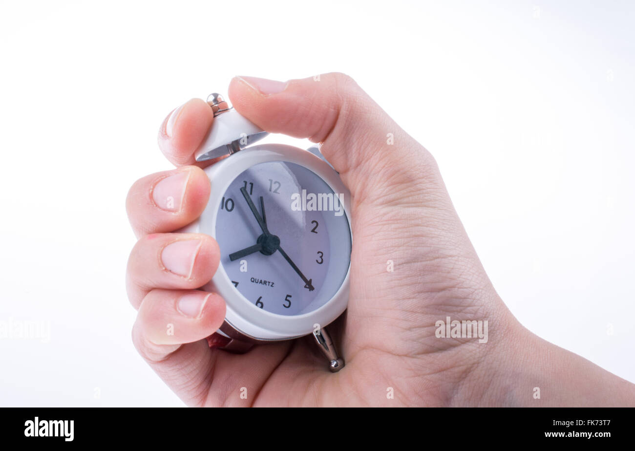 Alarm clock in hand on a white background Stock Photo - Alamy