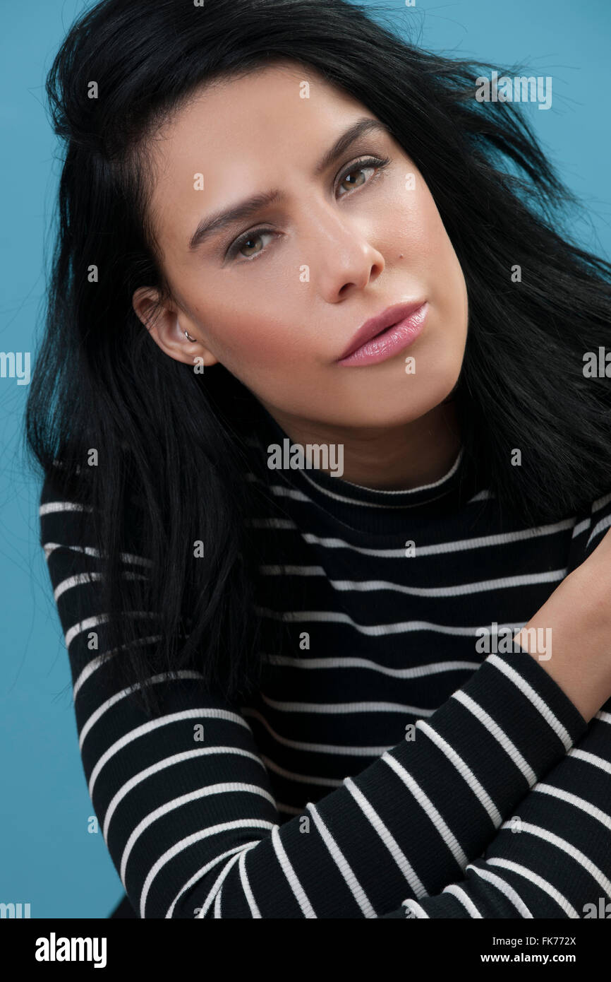 Female model with black hair pouting Stock Photo - Alamy