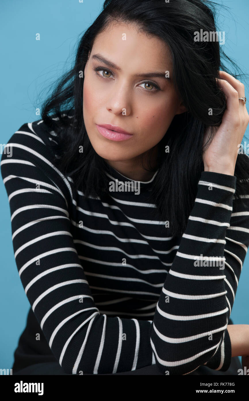 Female model with black hair deep in thought Stock Photo - Alamy