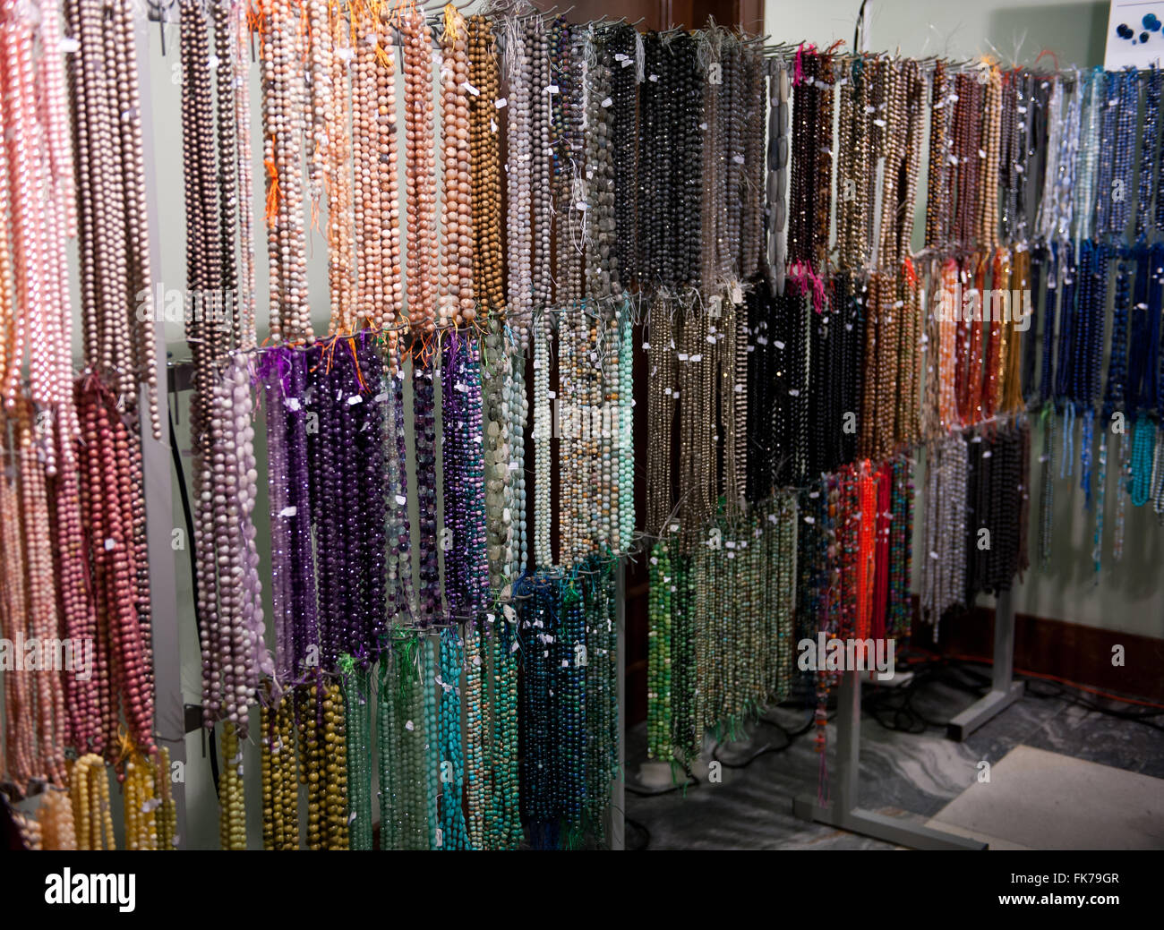 Hanging colorful beads gems, chains stand at the Warsaw Mineral Expo ...