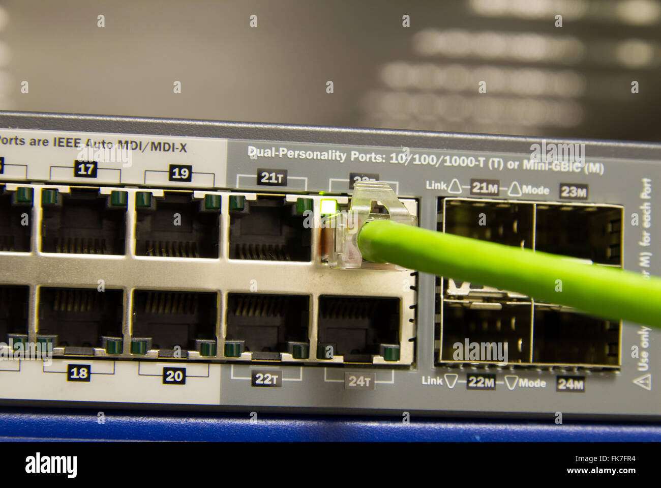 green ethernet cable plugged into server port Stock Photo - Alamy