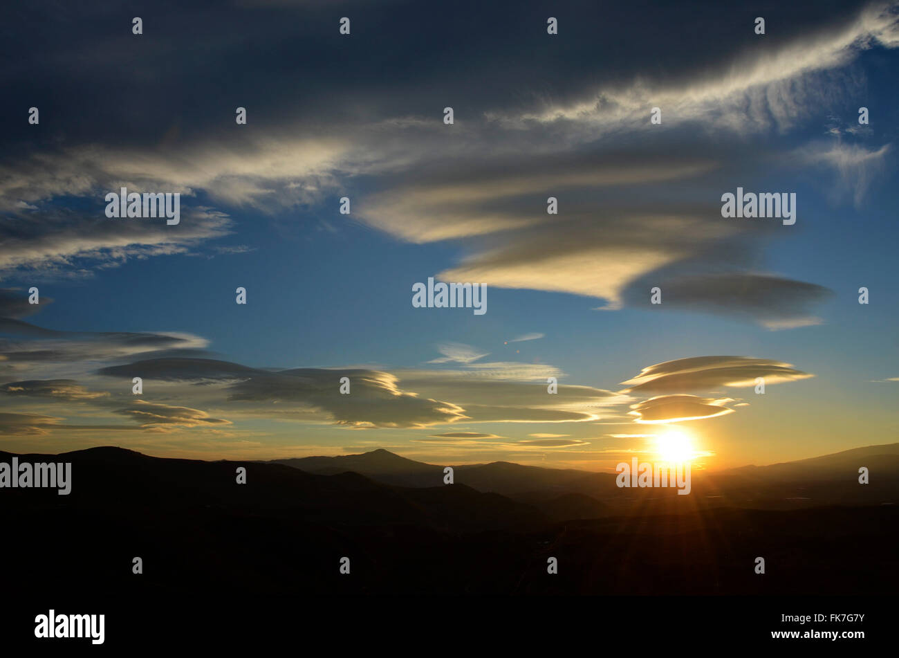 Sunset with sun rays Stock Photo - Alamy