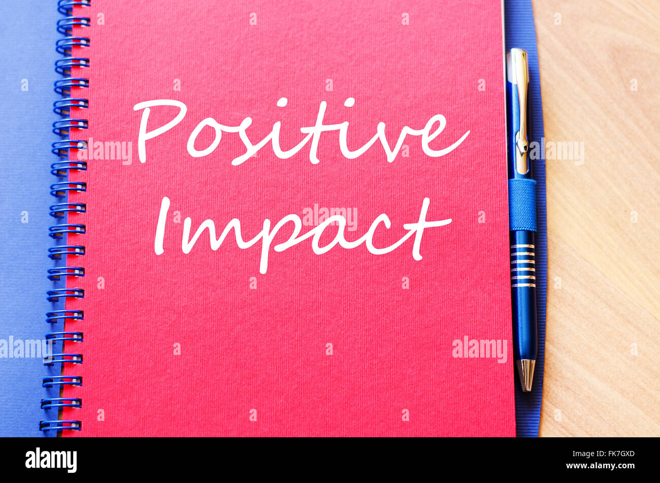 Positive impact text concept write on notebook with pen Stock Photo - Alamy