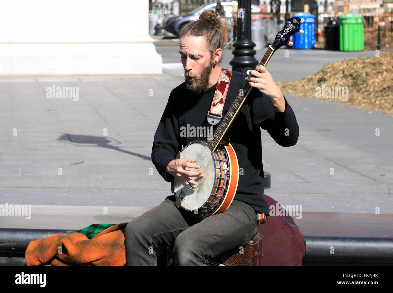 Young man playing musical instrument Washington Square Park Greenwich ...