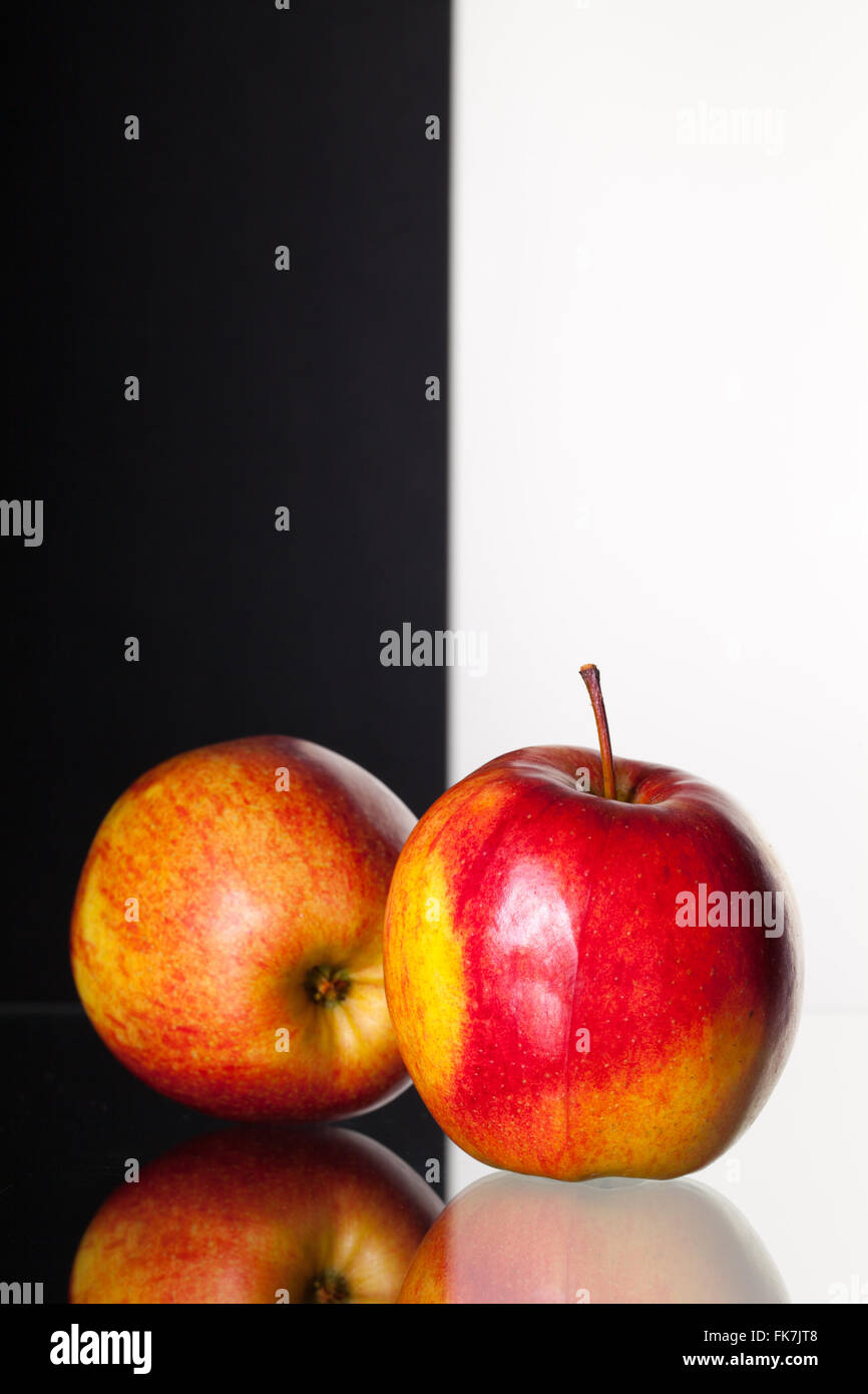Two apples isolated on black and white background and glass desk Stock ...