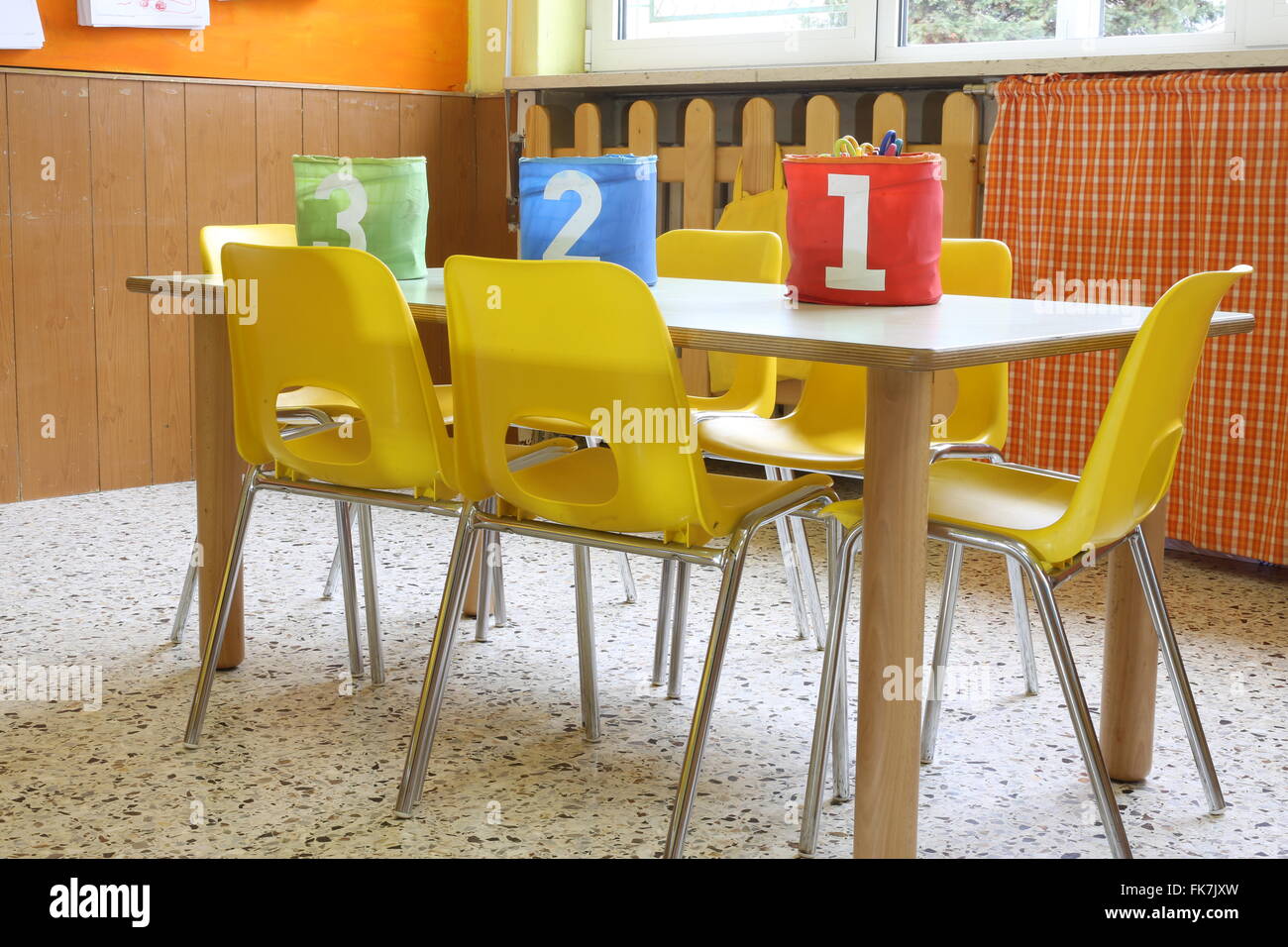 kindergarten class with the yellow chairs and small tables and boxes ...