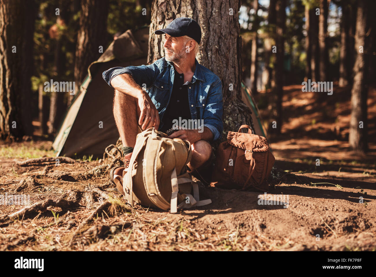 Man sitting alone under tree hi-res stock photography and images - Alamy
