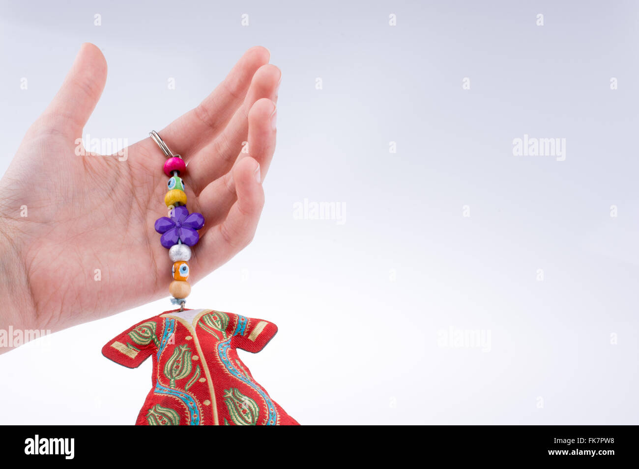 Hand holding traditional clothes with ornaments Stock Photo - Alamy