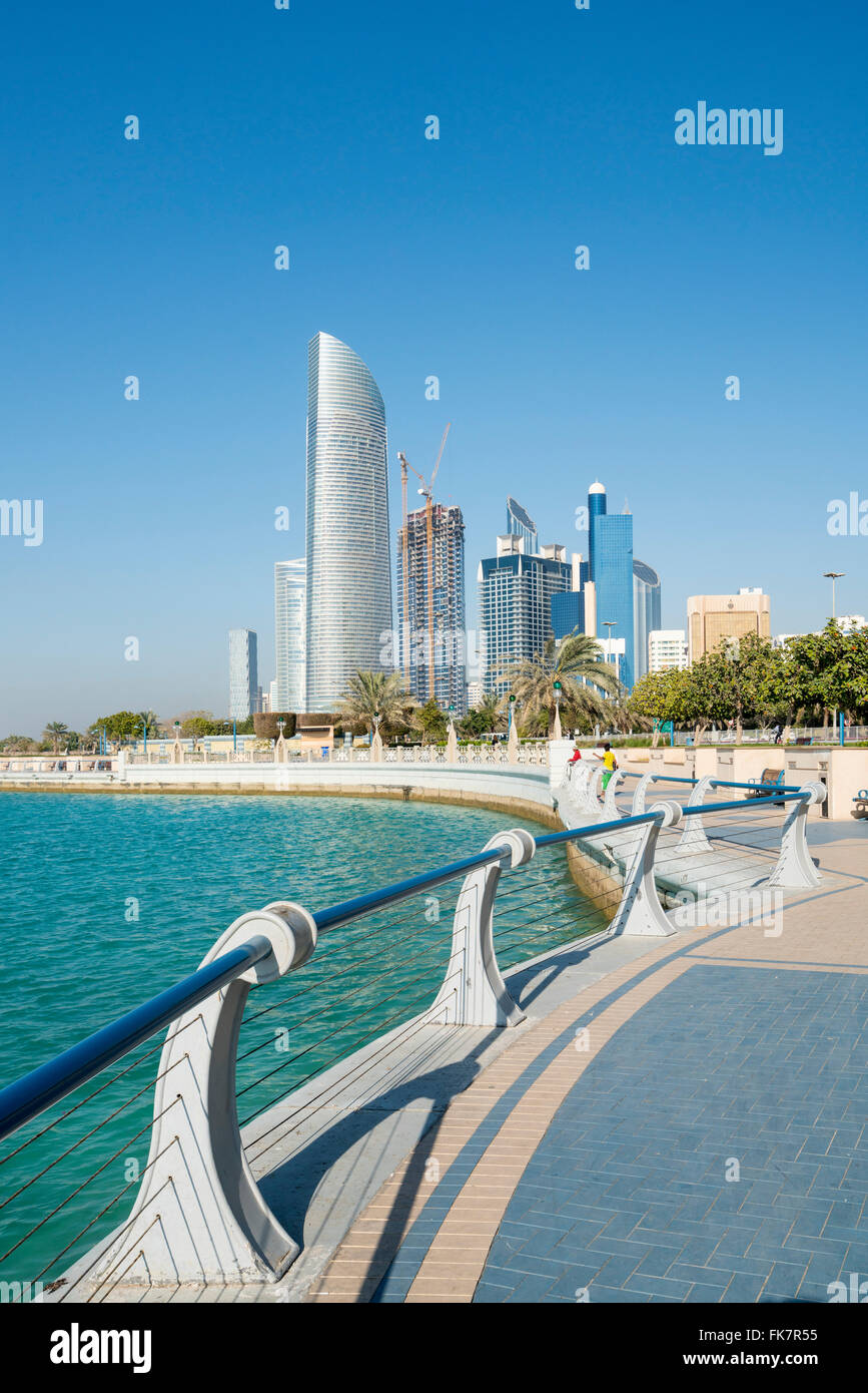 View along waterfront of Corniche towards modern office towers in Abu ...