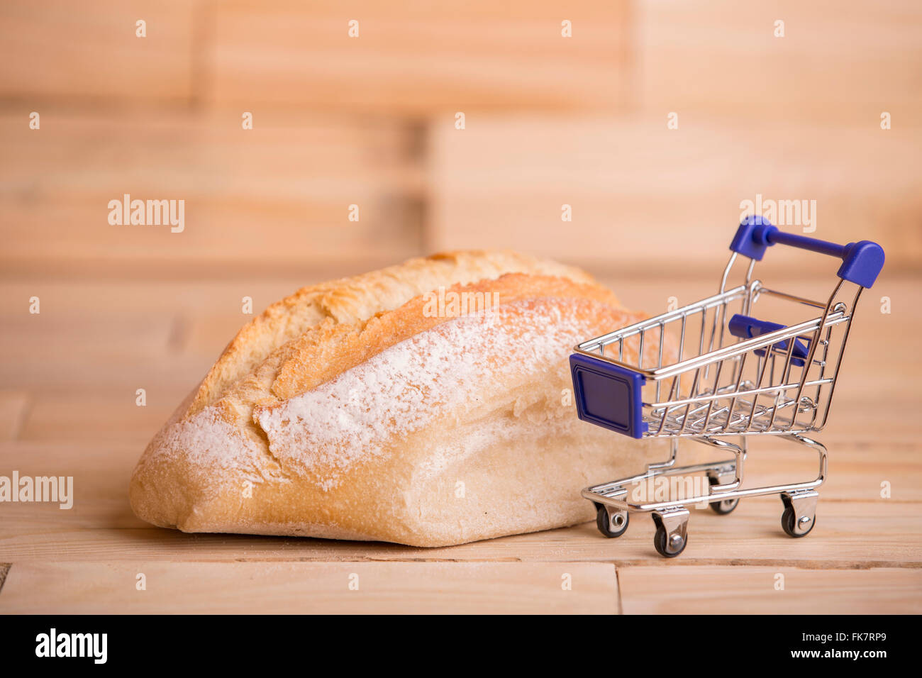 bread on wooden table with a shopping cart, studio picture Stock Photo ...
