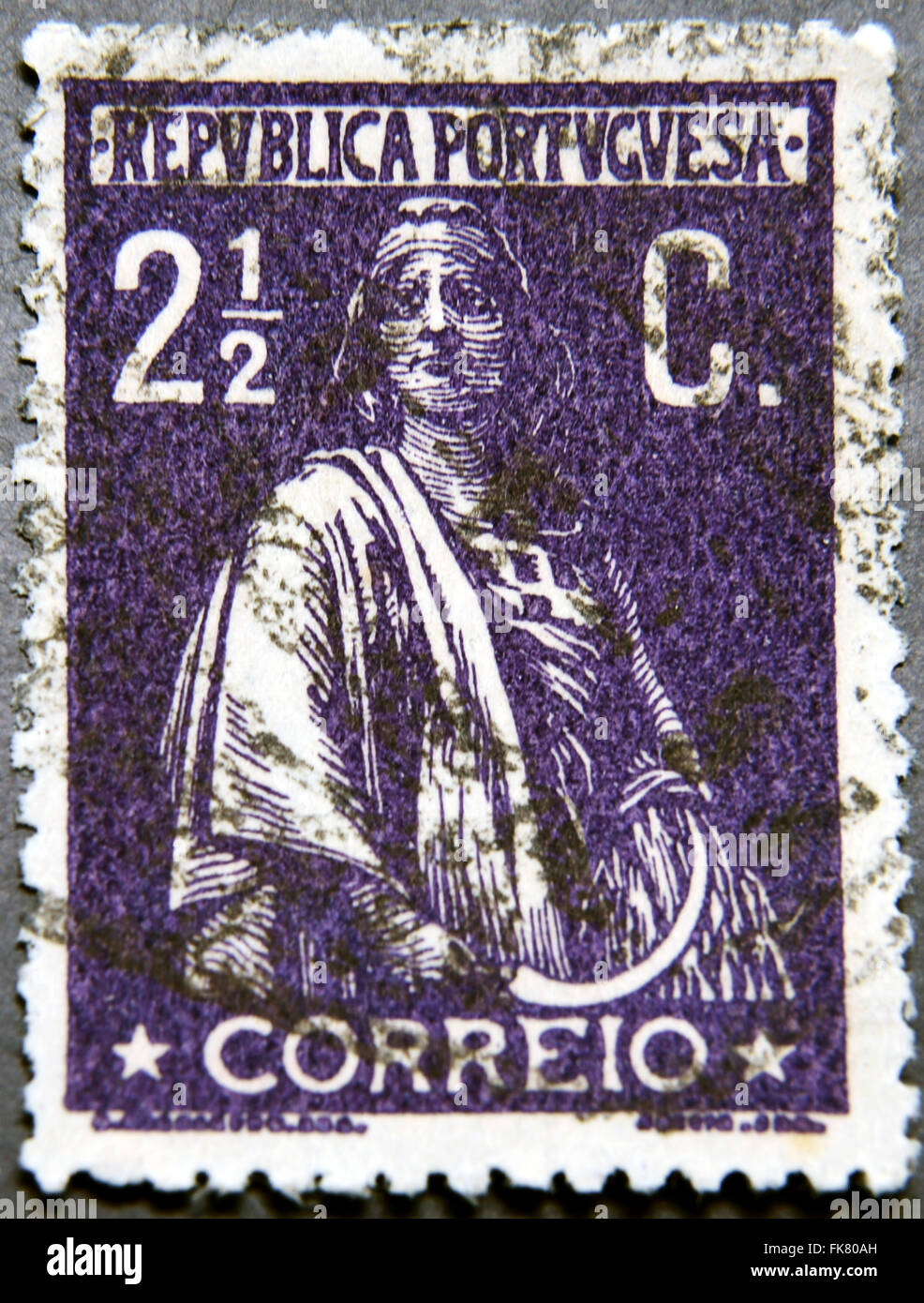 PORTUGAL - CIRCA 1935: A postage stamp of Portugal shows image of a woman with a sickle Stock ...