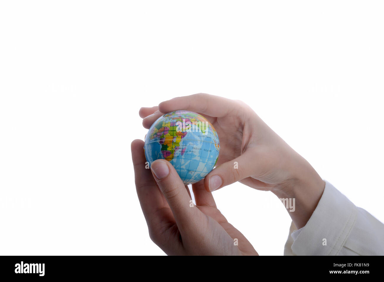 Child holding a small globe in hand on white background Stock Photo - Alamy