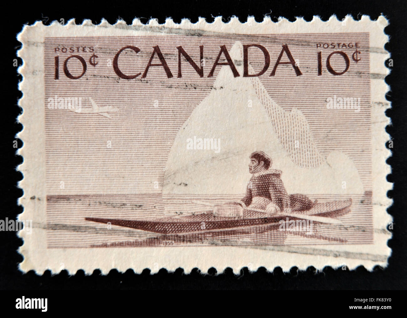 CANADA - CIRCA 1955: stamp printed in Canada shows Eskimo on a kayak ...