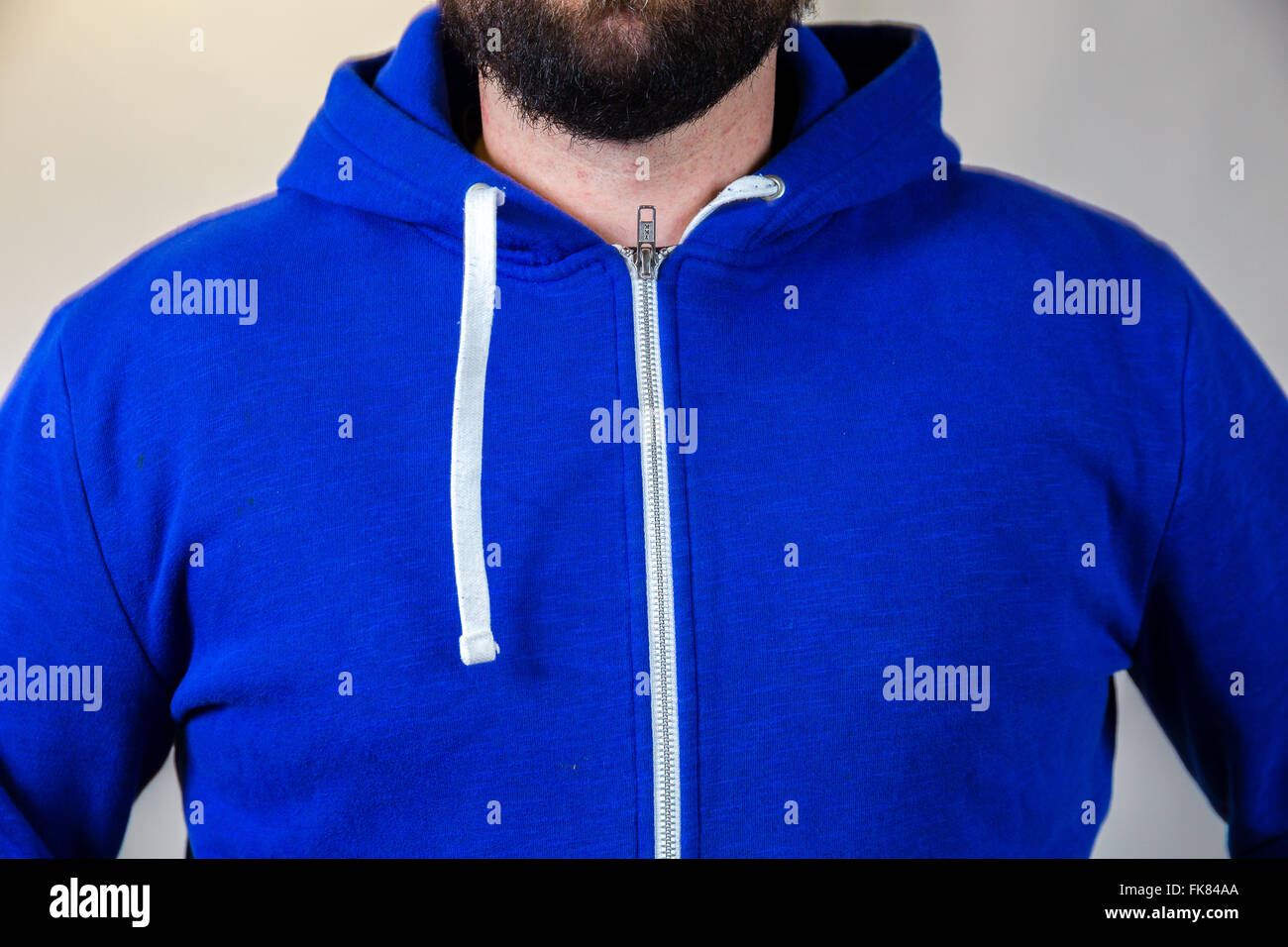 Man in his mid-30's poses for a studio portrait with a semi white ...