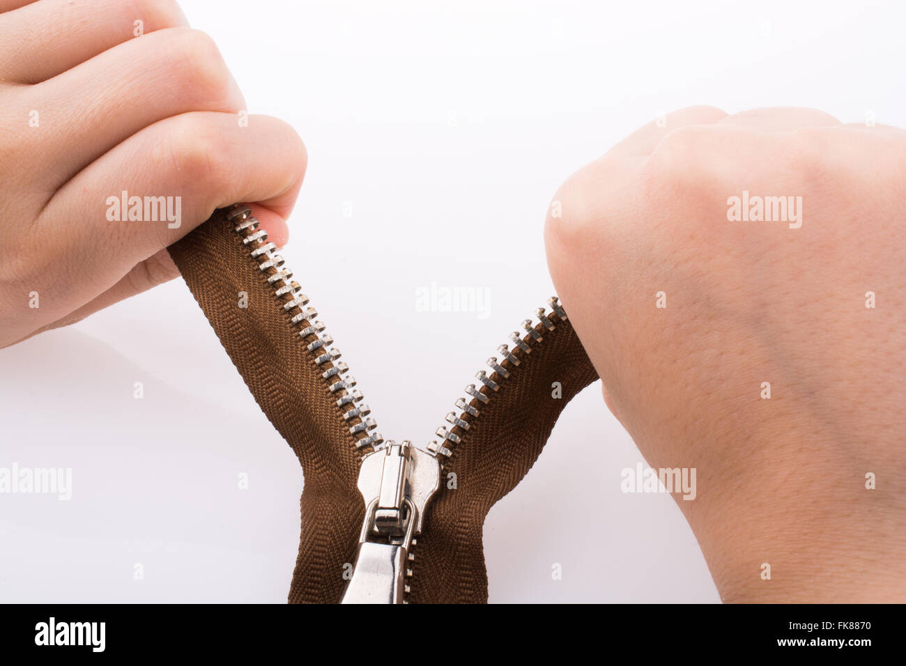 Hand holding color zipper on a white background Stock Photo - Alamy