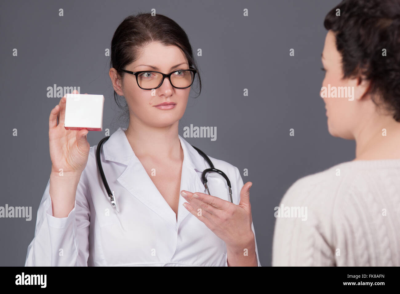 Pharmacist giving a drug box to a patient. doctor recommends a new ...