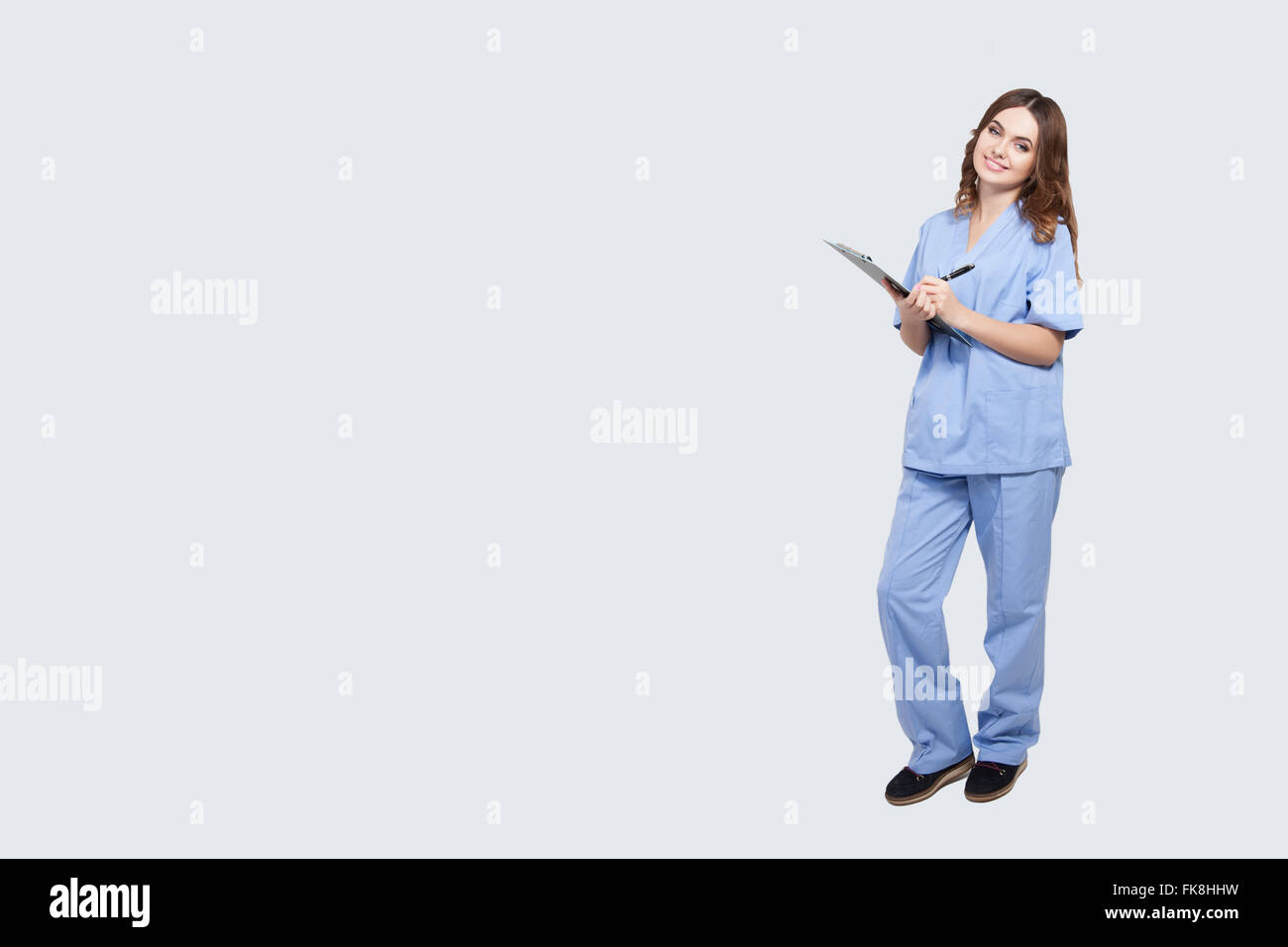 Caucasian doctor in blue uniform, doctor holding documents, friendly ...