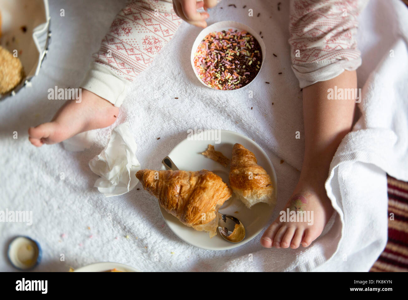 Little girl eating breakfast in pajamas on a hotel room floor Stock ...