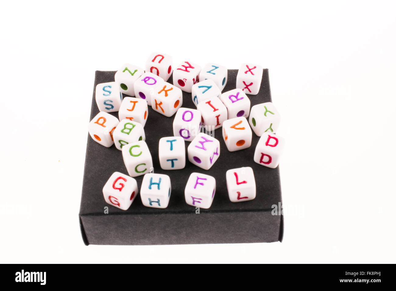 letter cubes placed on a box on a white background Stock Photo - Alamy