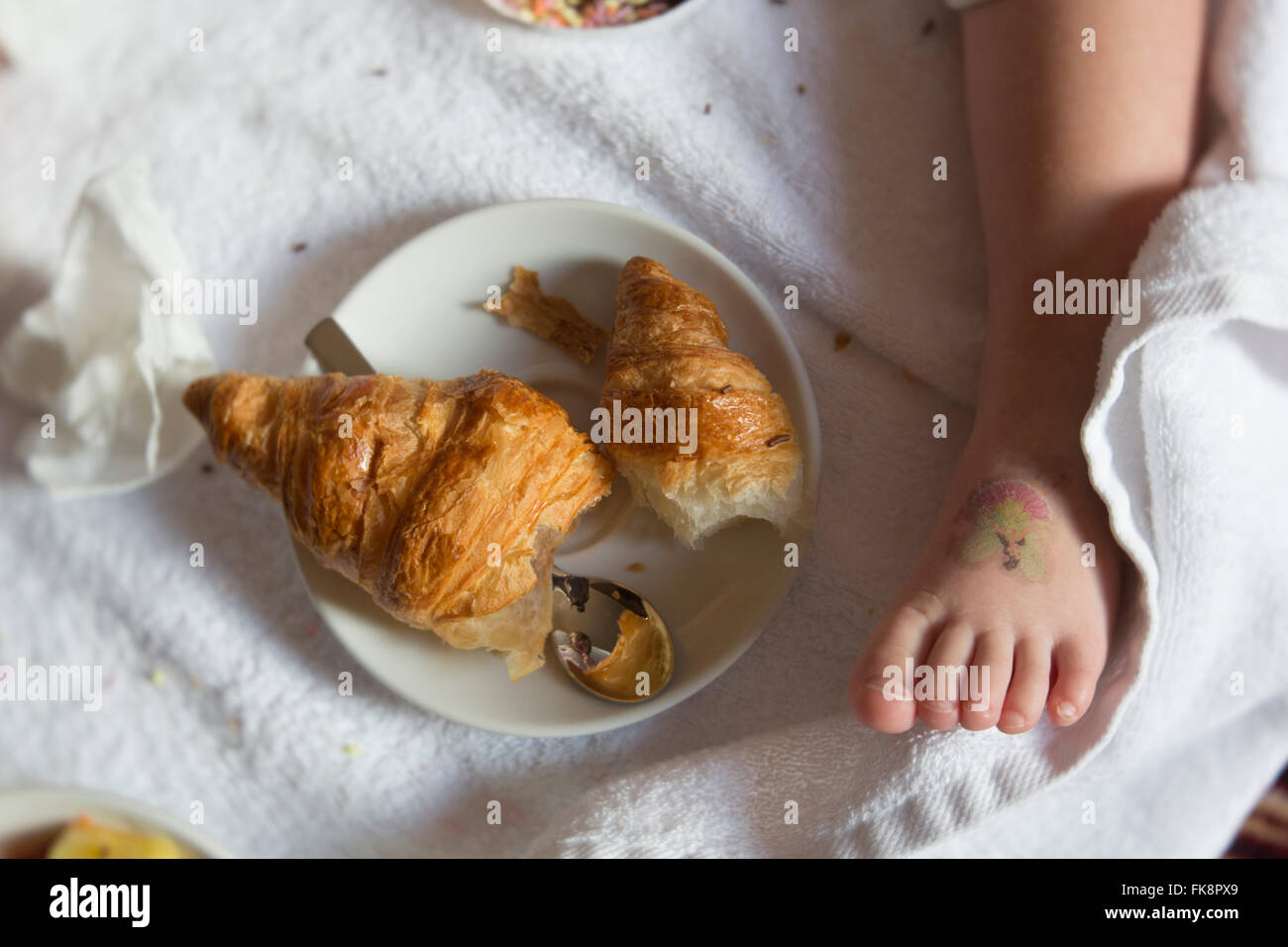 Little girl eating breakfast in pajamas on a hotel room floor Stock ...